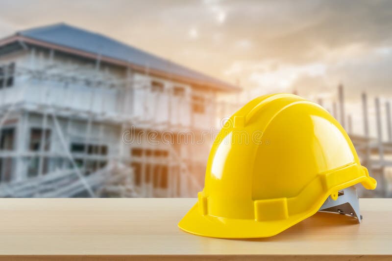 Safety Construction Helmet on Wood Table with Construction Site ...