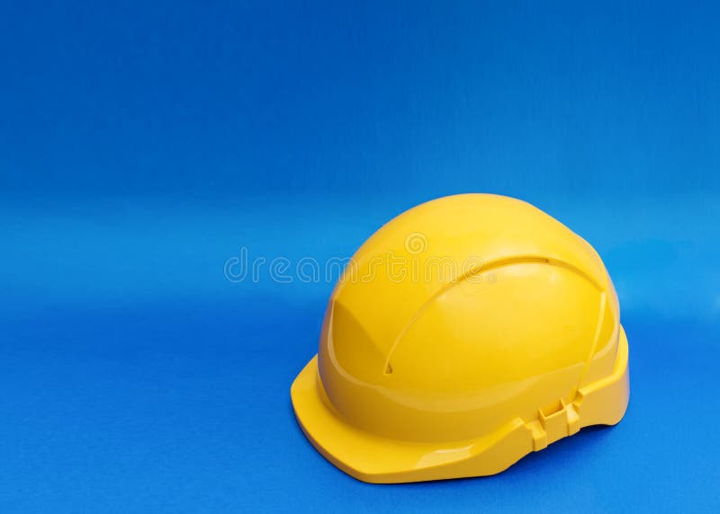 Yellow Safety Helmet on Blue Background Stock Image - Image of helmet ...