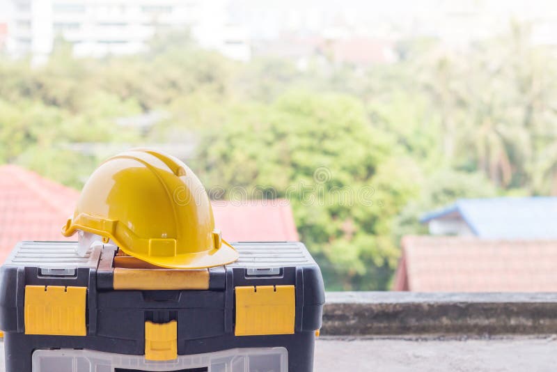 The Yellow Safety Helmet on the Tool Box at Construction Site Stock ...
