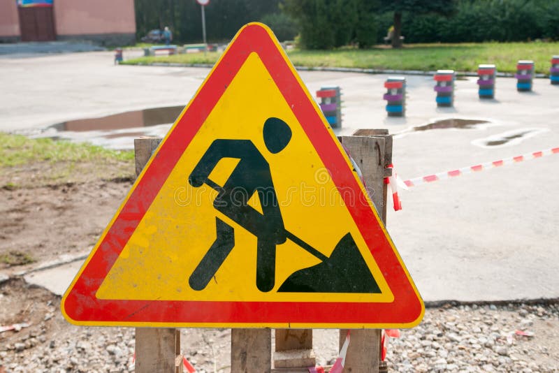 Yellow Safety Sign Warns Roadworks Under Construction Sign Stock Photos ...
