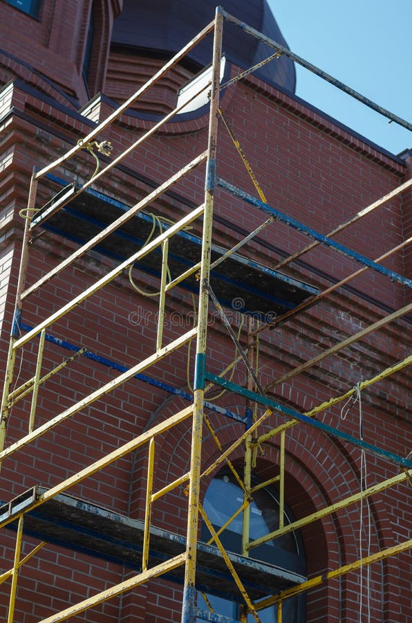 Yellow Scaffolding in Front of the Red Brick Building. Construct Stock ...