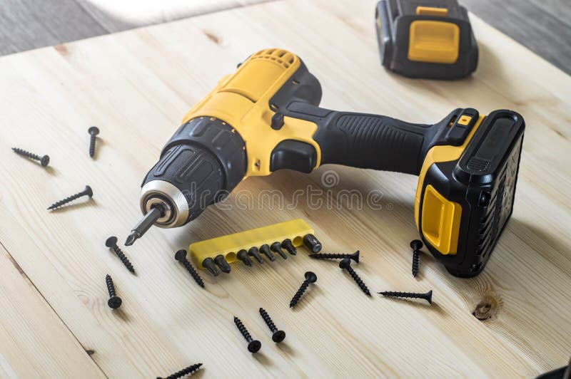 Yellow Screwdriver on a Wooden Table, Screws, a Set of Bits. Stock ...