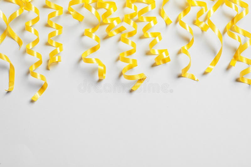 Yellow Serpentine Streamers on White Background. Festive Decor Stock ...