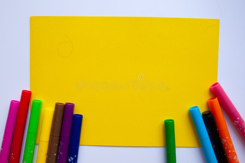 A Yellow Sheet of Paper with Markers Along the Edge of the Paper Stock ...