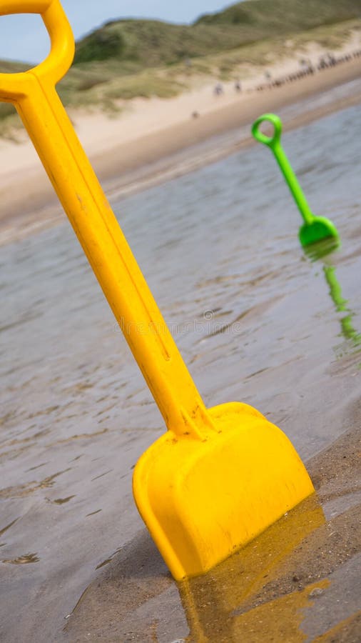 Yellow Shovel Standing on a Beach Stock Photo - Image of nature, child ...