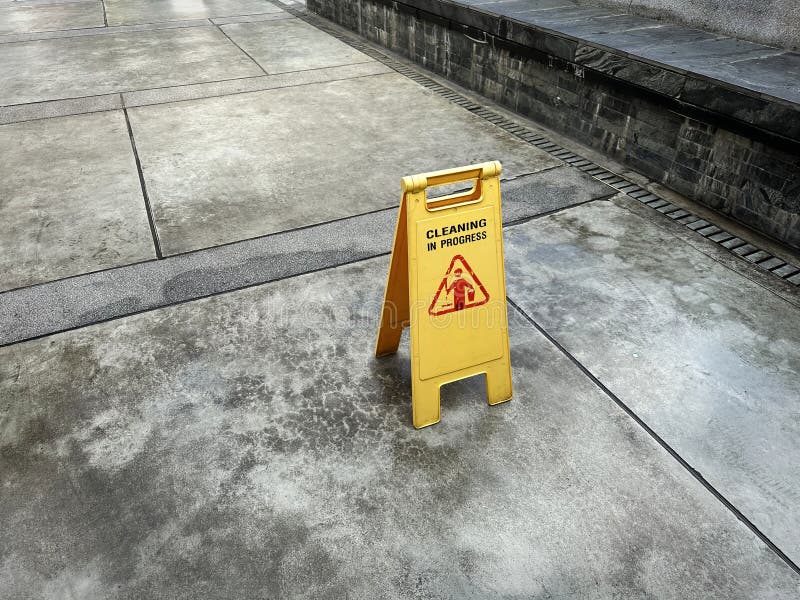 Yellow Sign on the Floor with Cleaning in Progress Message Stock Image ...