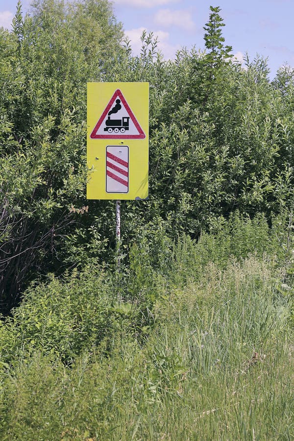 A Yellow Sign with a Red and White Triangle on it Stock Photo - Image ...
