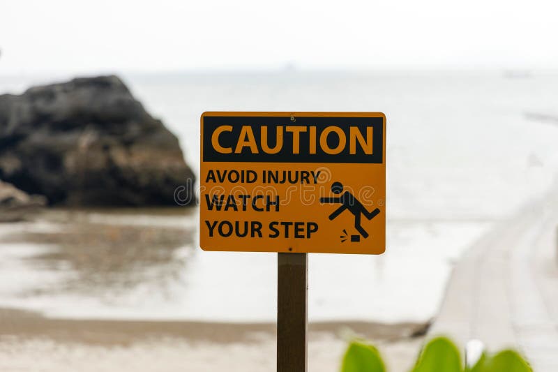 Yellow Sign Warning Against Injury Stock Photo - Image of trail ...