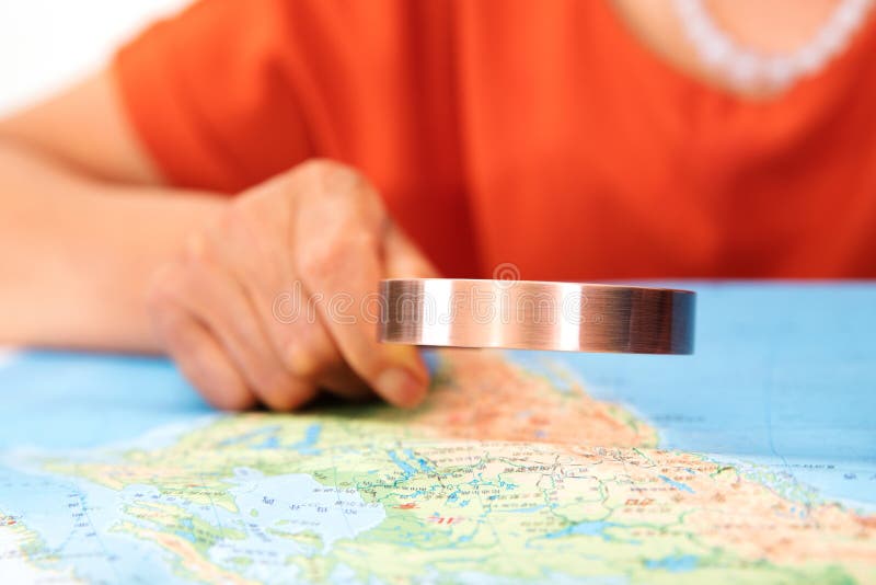 The Yellow-skinned Old Lady is Looking Up on the World Map with a ...