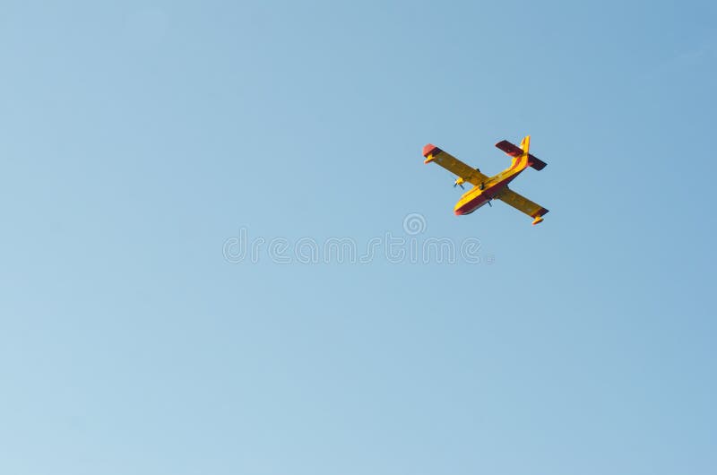 Yellow Small Plane with Red Lines Flying on Clear Blue Sky Stock Photo ...