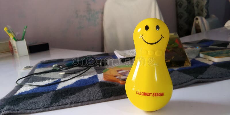 Yellow smiley on the desk stock image. Image of yellow - 156155031