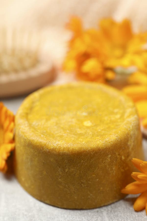 Yellow Solid Shampoo Bar and Flowers on Light Table, Closeup. Hair Care ...