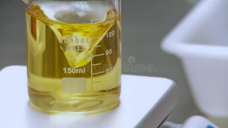 Yellow Solution in a Beaker Agitated with Magnetic Stirred in the ...