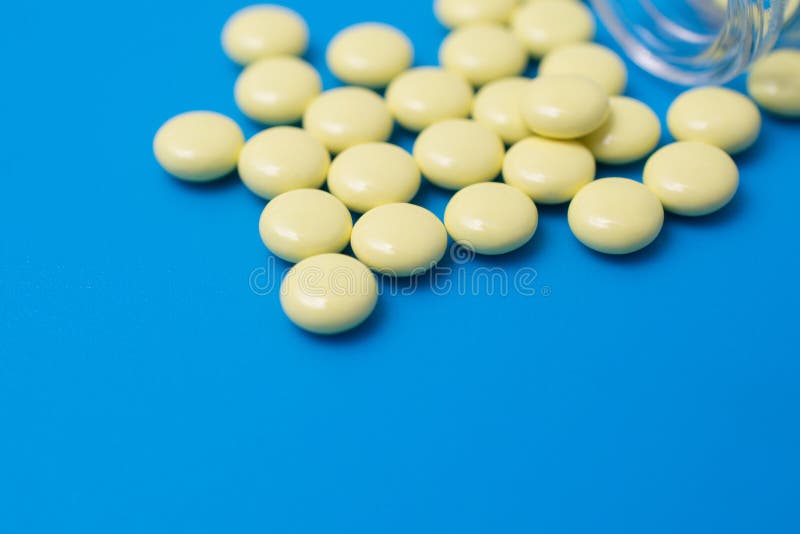 Yellow soothing tablets stock photo. Image of glass - 140516764