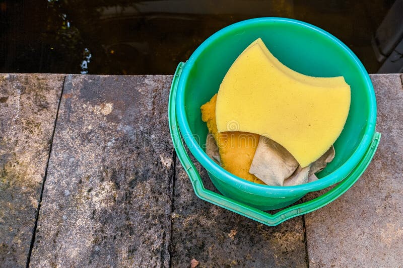 Yellow Sponge in a Green Bucket by the Pool Stock Photo - Image of ...