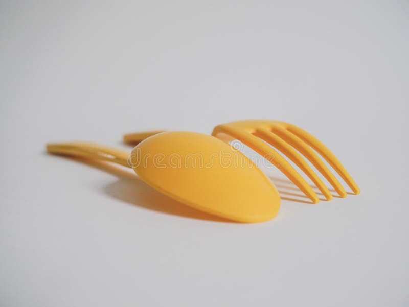 Yellow Spoon and Fork on White Background Stock Photo - Image of white ...