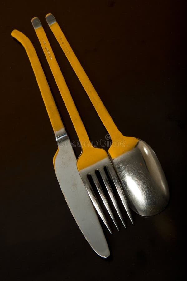 Yellow Spoon Knife and Fork Stock Photo - Image of silver, shiny: 4642062