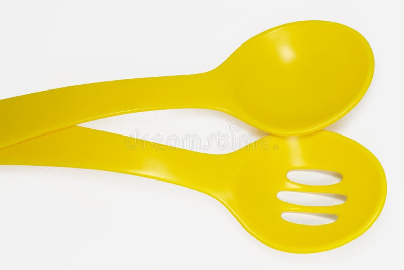 Yellow spoons stock image. Image of hole, shiny, orange - 4172017