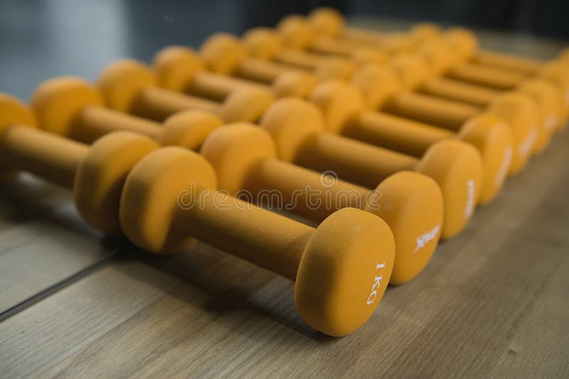 Yellow sport dumbbells stock image. Image of strong - 113500645