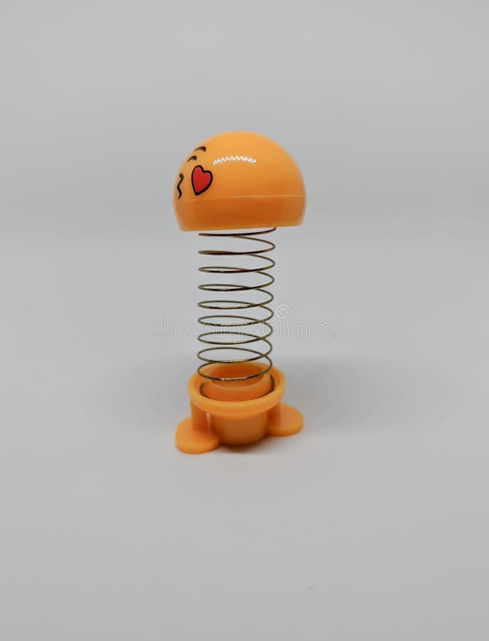 Yellow Spring Toy with Emoticon Face Shape on White Background Stock ...
