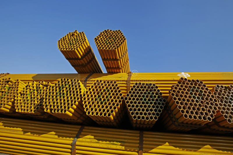 Yellow stacked steel pipe stock photo. Image of mode - 225828556