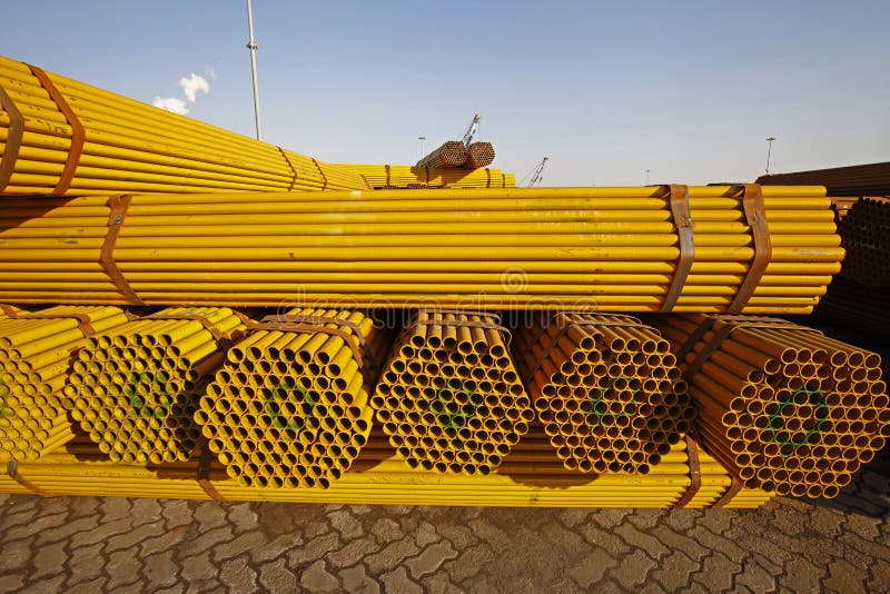 Yellow stacked steel pipe stock photo. Image of abstract - 225828600