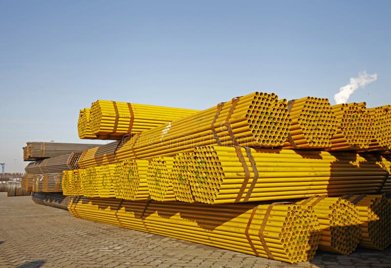 Yellow stacked steel pipe stock photo. Image of round - 319068976