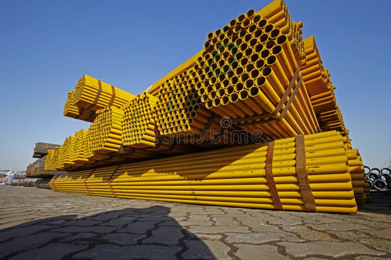 Yellow stacked steel pipe stock photo. Image of industrial - 319069014