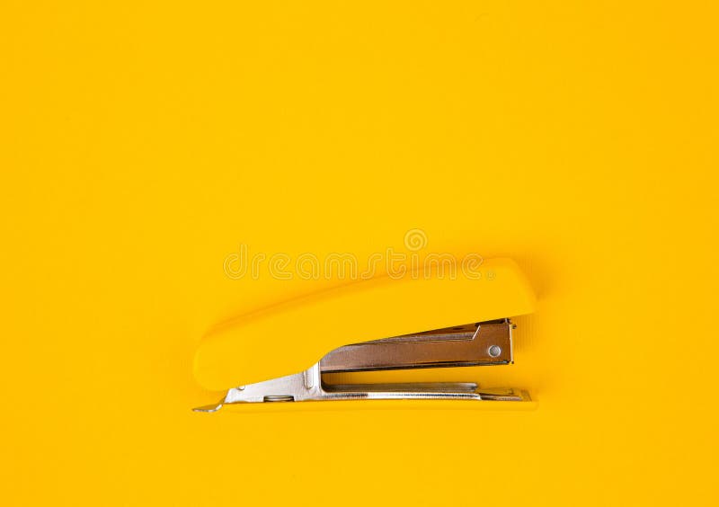 Yellow Stapler on Yellow Background. Top View. Copy, Empty Space for ...