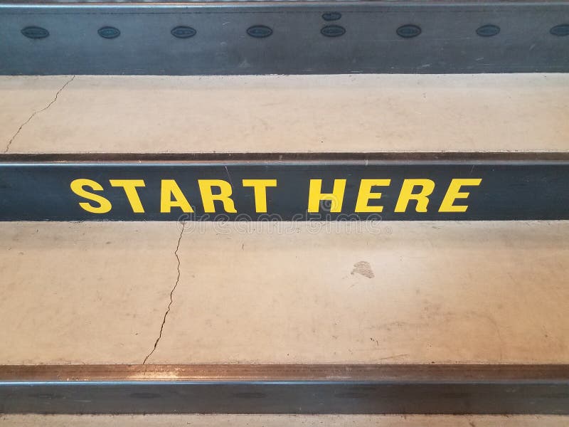 Yellow Start Here Sign on Black and Grey Cement Stairs Stock Photo ...
