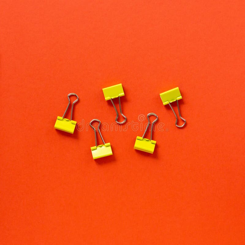 Yellow Stationery Clips on a Bright Red Background Stock Photo - Image ...