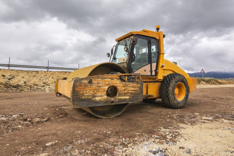 Yellow Steamroller Performing Ground Leveling Work Stock Photo - Image ...