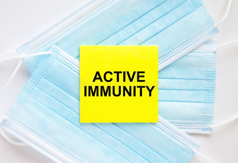 Yellow Sticker with Text Active Immunity Lying on the Masks Stock Image ...