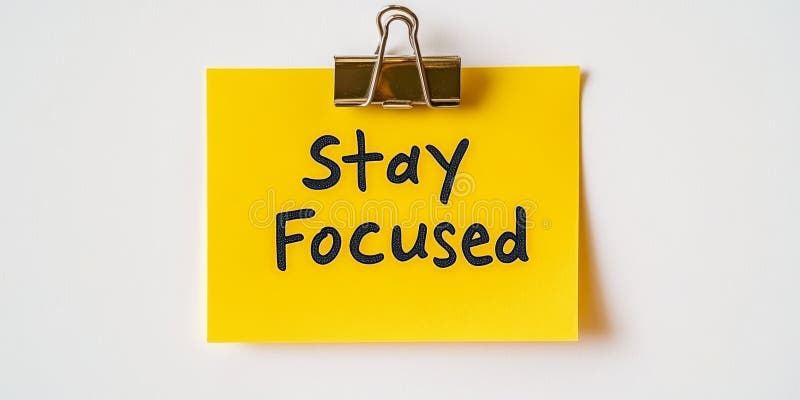 Yellow Sticky Note with Stay Focused Message Attached with a Paper Clip ...