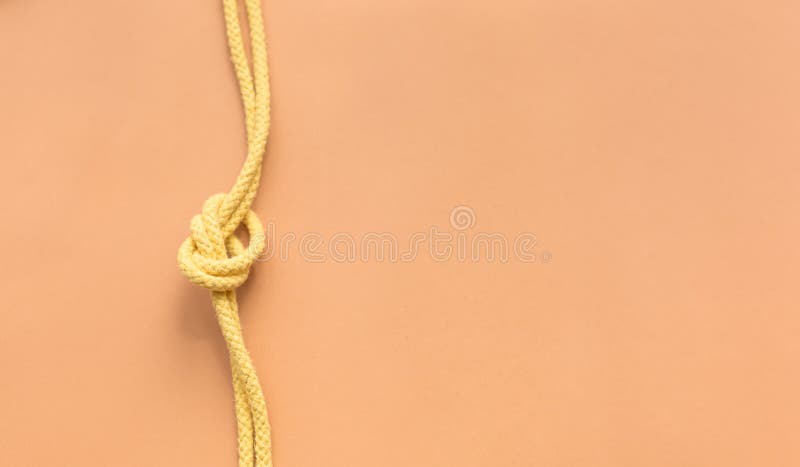 Yellow String Knotted on a Orange Colour Background Stock Image - Image ...