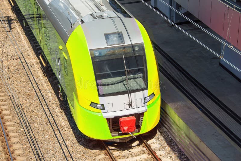 Yellow Suburban Electric Train at the Passenger Platform at the Station ...
