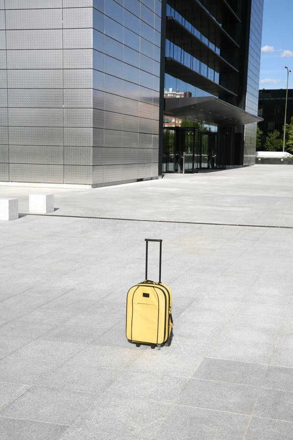 Yellow Suitcase in Front of Business Building Stock Photo - Image of ...