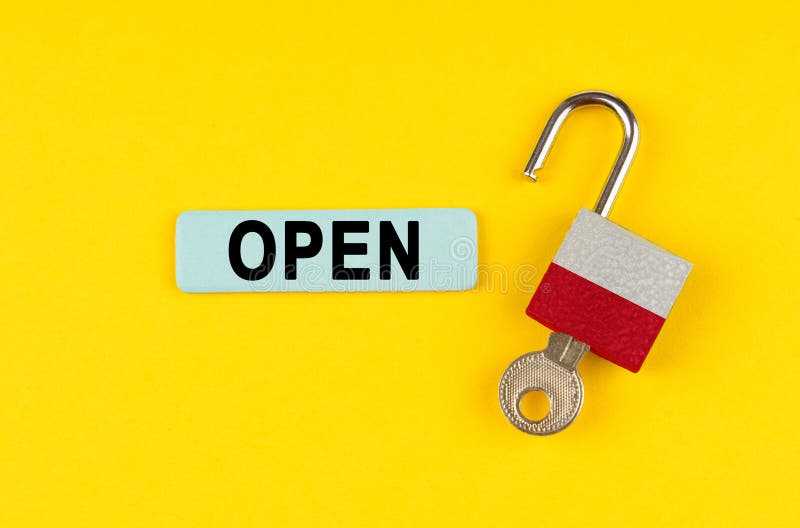 On the Yellow Surface is an Open Lock with a Key and a Sticker with the ...