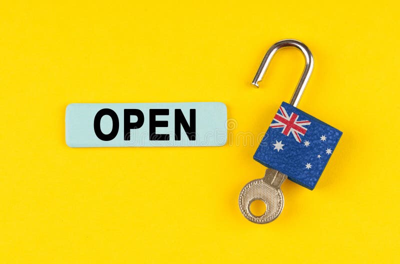 On the Yellow Surface is an Open Lock with a Key and a Sticker with the ...