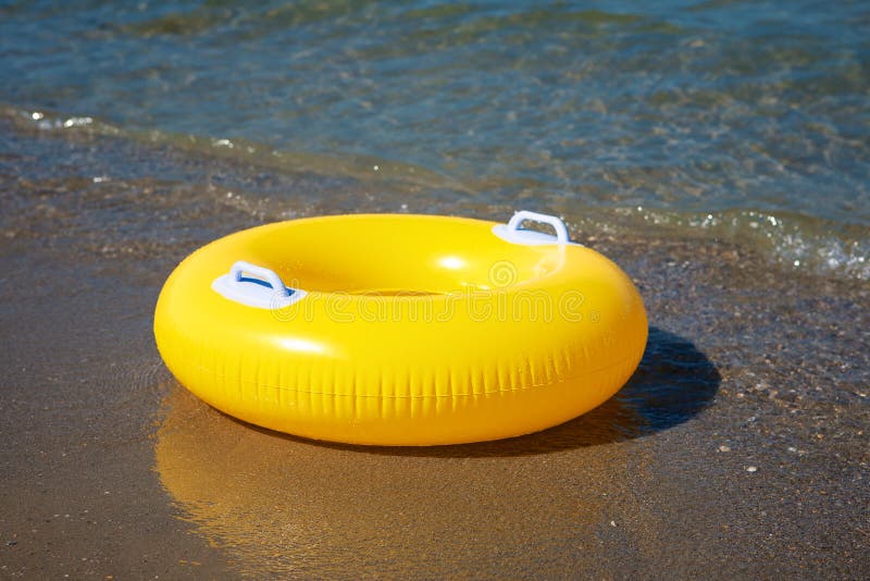 Yellow Swim Ring Floating on a Sea Stock Photo - Image of circle ...