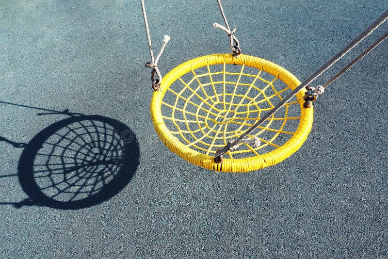 Yellow Swing in the Form of a Web and a Shadow from it. Stock Image ...