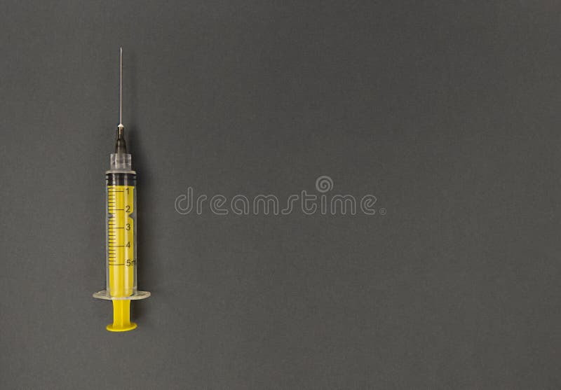 Yellow Syringe on Black Background Stock Image - Image of needle, drug ...