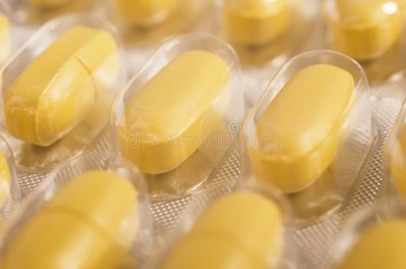 Yellow tablets closeup of stock image. Image of closeup - 30492663