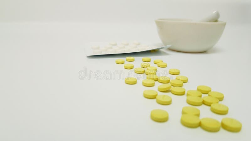 Yellow tablets compounding stock image. Image of mortar - 125351989