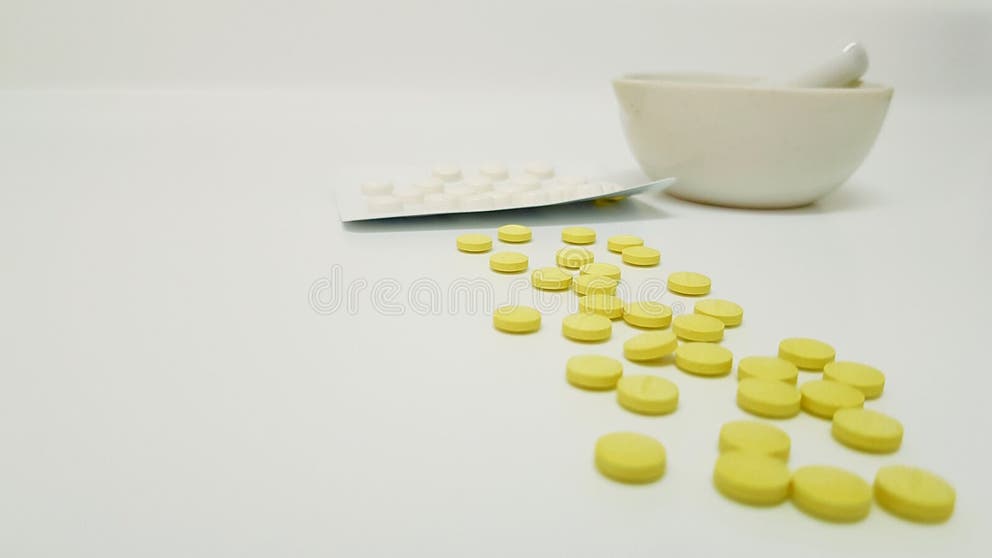 Yellow tablets compounding stock image. Image of mortar - 125351989