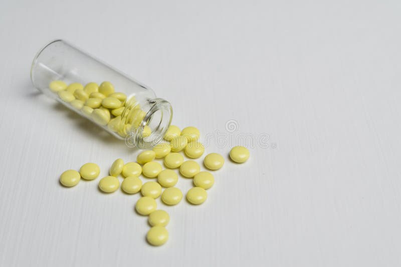 Yellow Tablets on a White Table Stock Image - Image of pharmacy ...