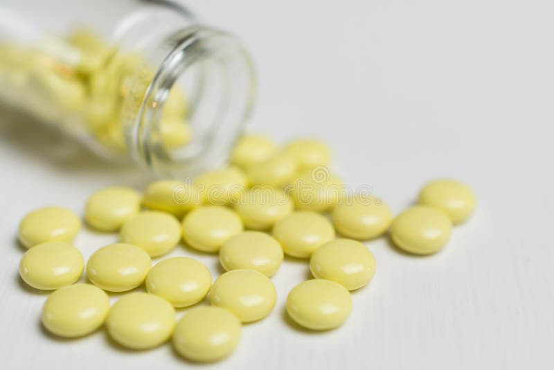 Yellow Tablets on a White Table Stock Photo - Image of production ...