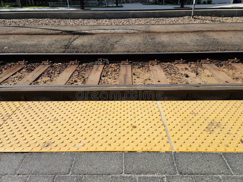 Yellow Tactile Bumps on Cement Next To Train Track Stock Photo - Image ...