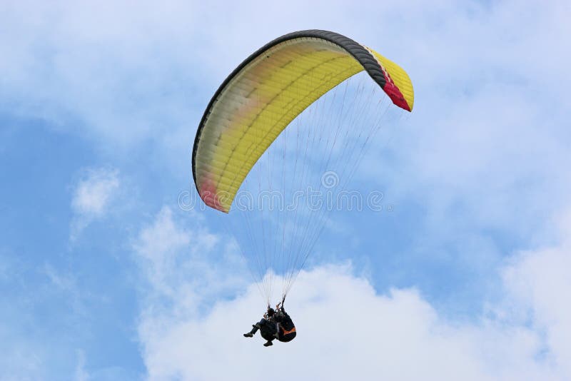 Yellow Tandem Paraglider Flying in a Blue Sky Stock Photo - Image of ...