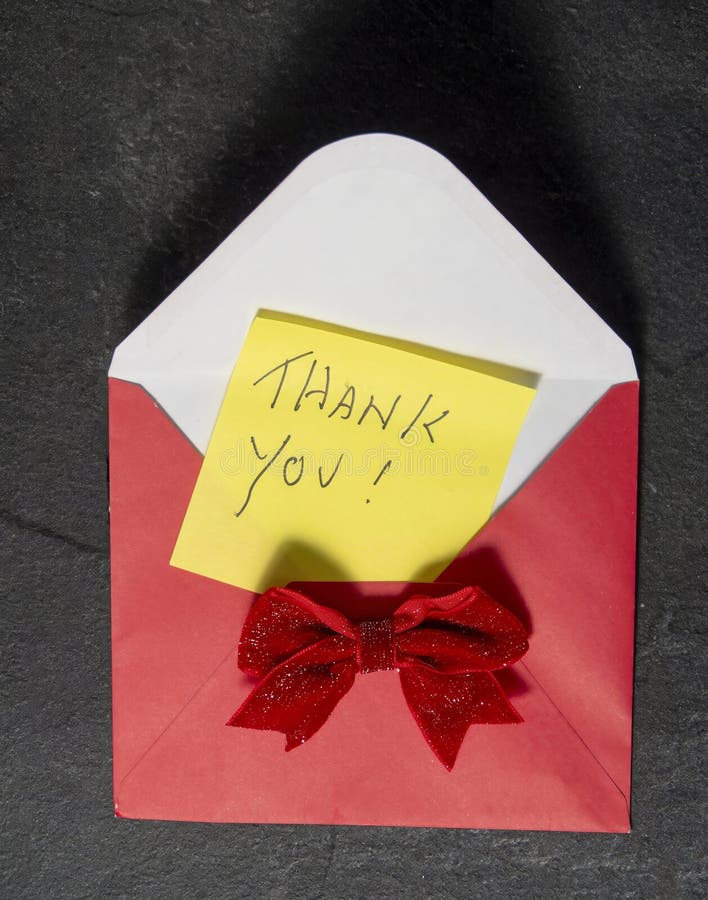 Yellow Thank You Post-it Note on a Red Envelope and Red Bow on a Slate ...